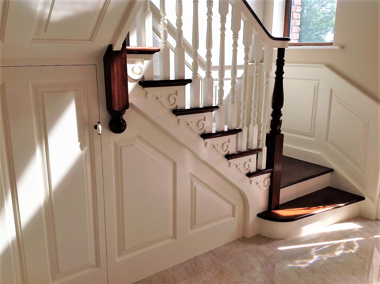 Mahogany and ivory cut string stairs with continuous handrail and wall ...