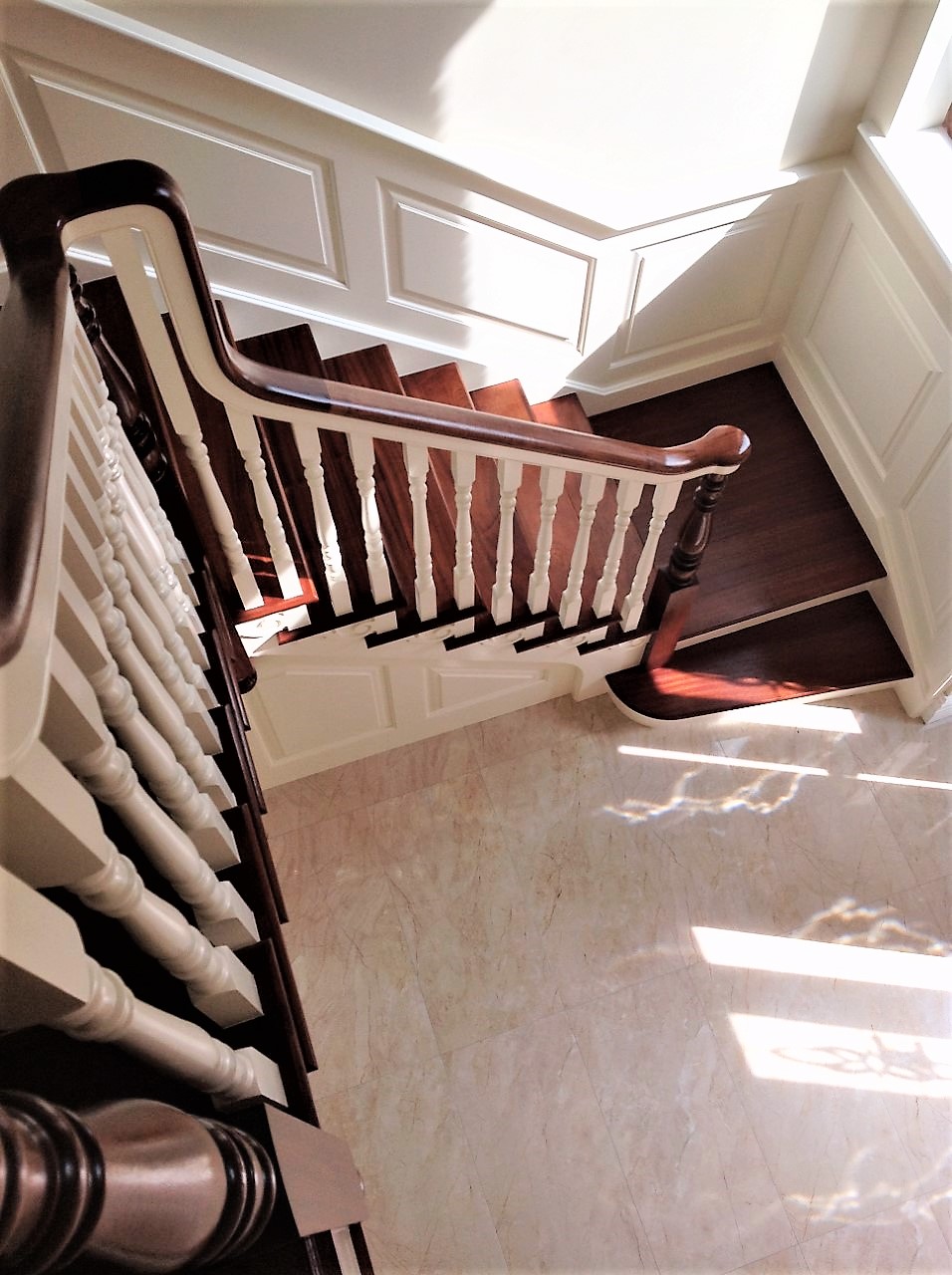 Mahogany and ivory cut string stairs with continuous handrail and wall ...