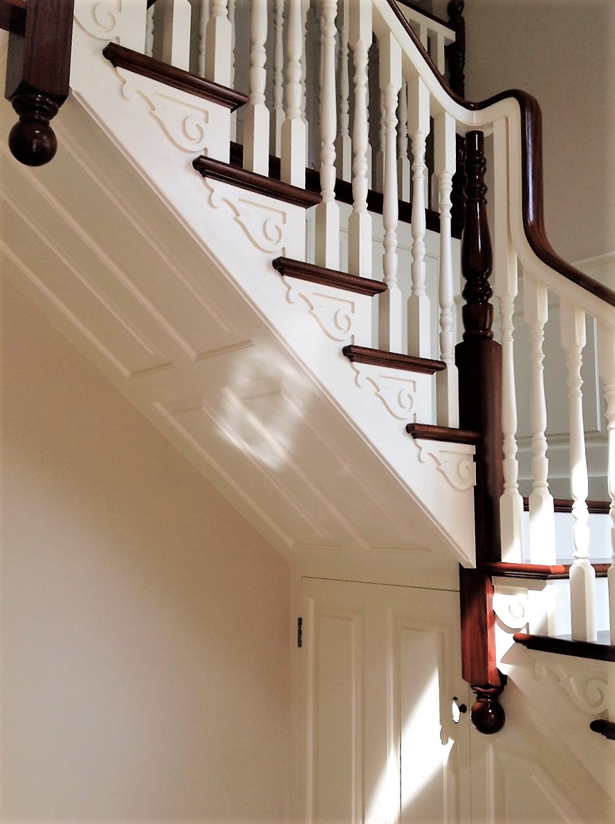 Mahogany and ivory cut string stairs with continuous handrail and wall ...