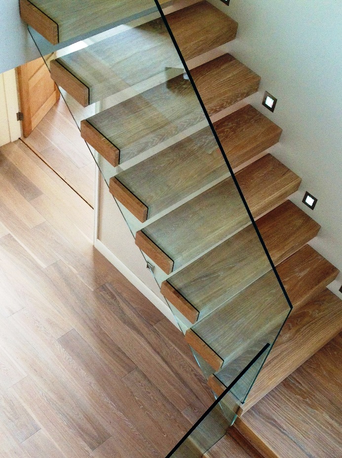 Floating limed European oak stairs with inset glass balustrade