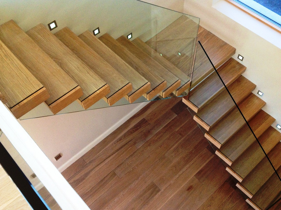 Floating limed European oak stairs with inset glass balustrade