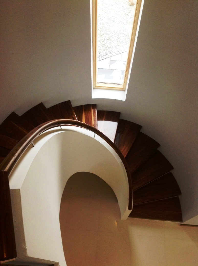 Curved concrete stairs - Cladded with walnut treads and inset curved ...