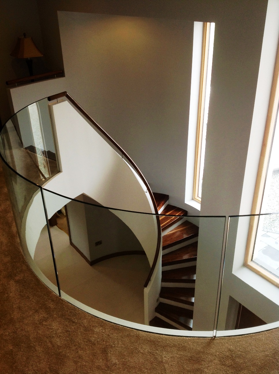 Curved concrete stairs - Cladded with walnut treads and inset curved ...